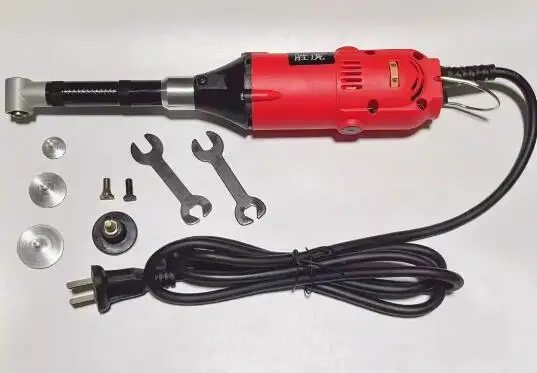 A red 220V micro angle grinder with accessories, including wires ...