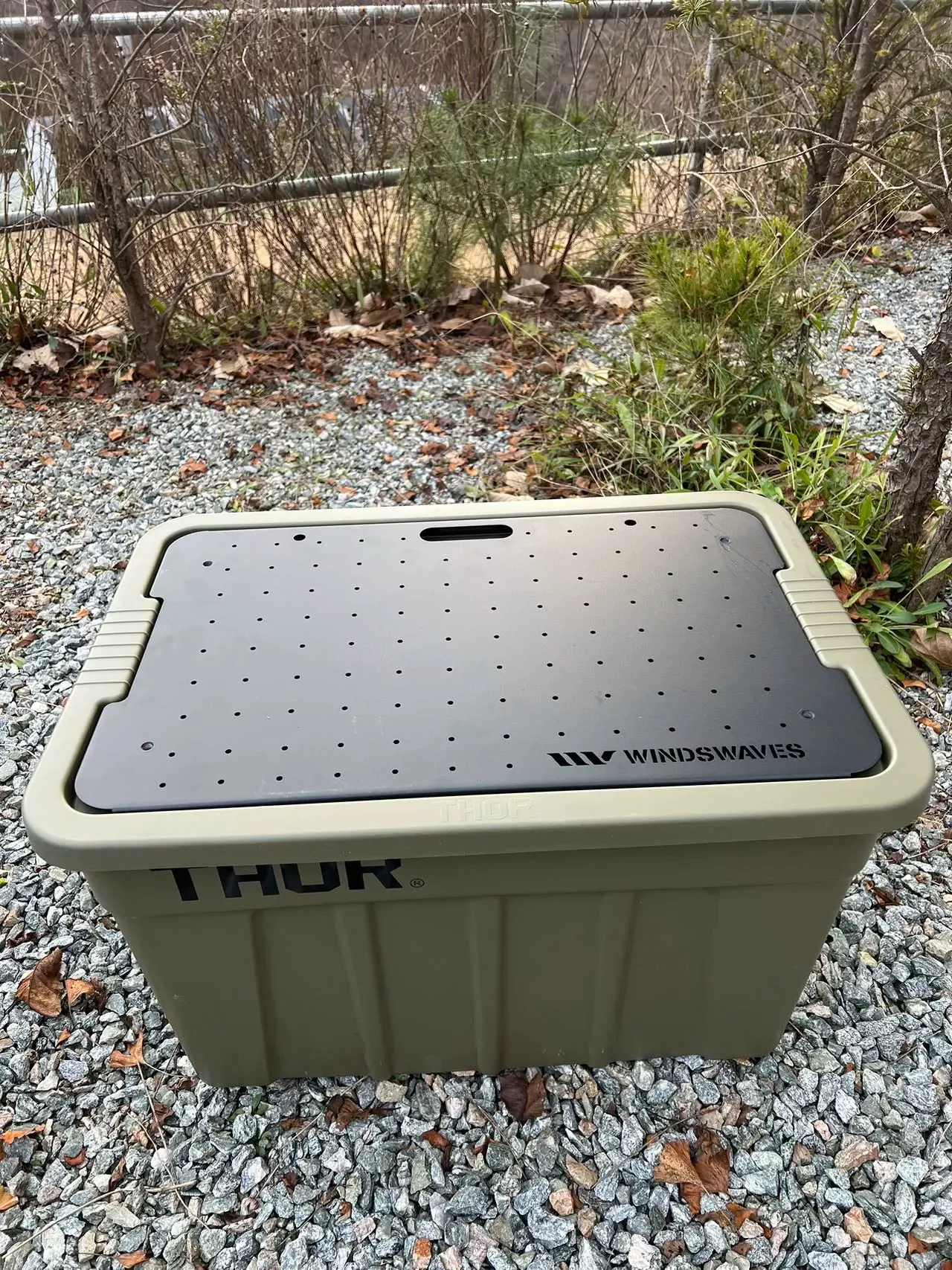 A portable, foldable table with a grid pattern on top, designed for ...